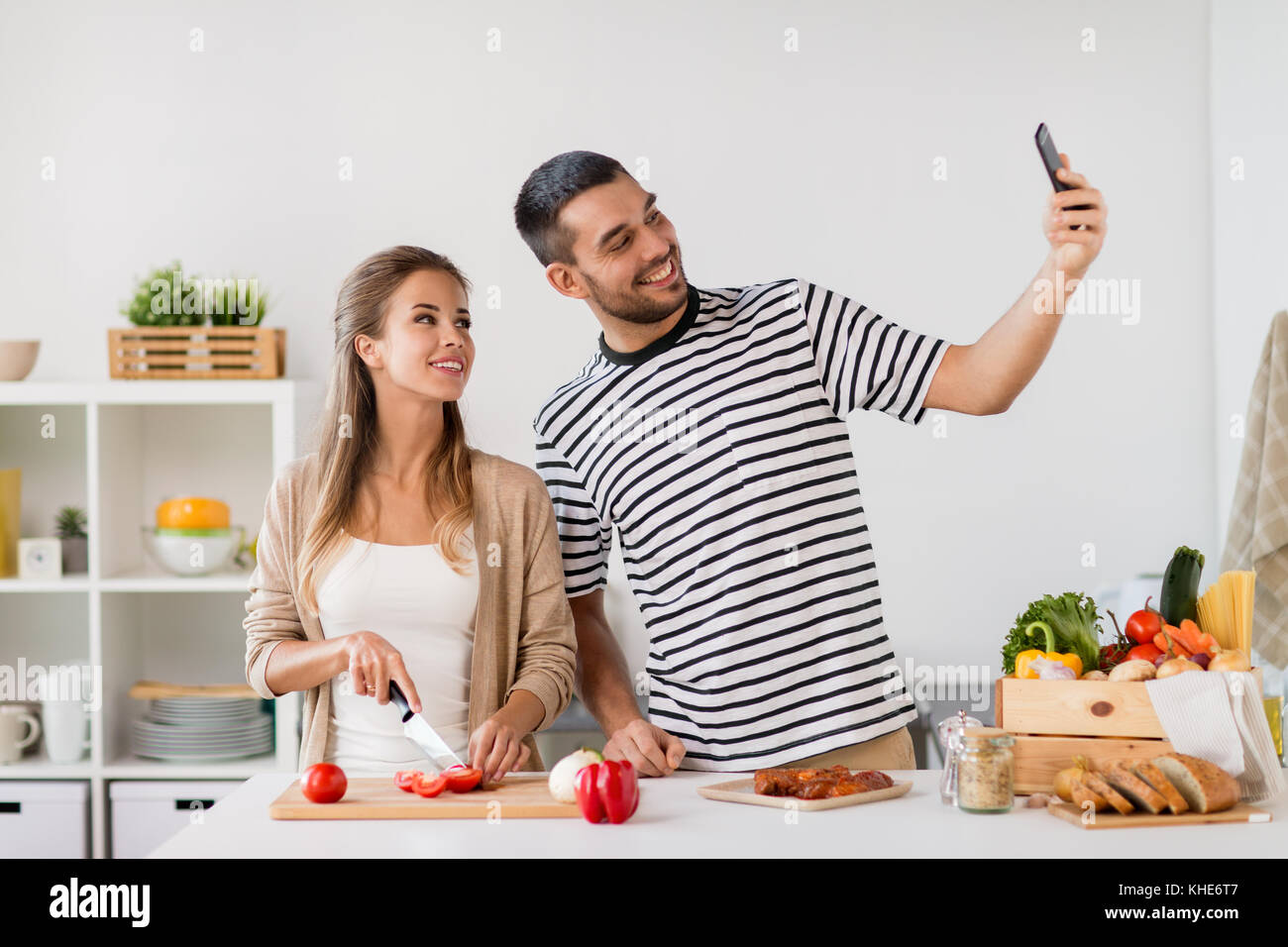 couple cooking food and taking selfie at kitchen Stock Photo - Alamy