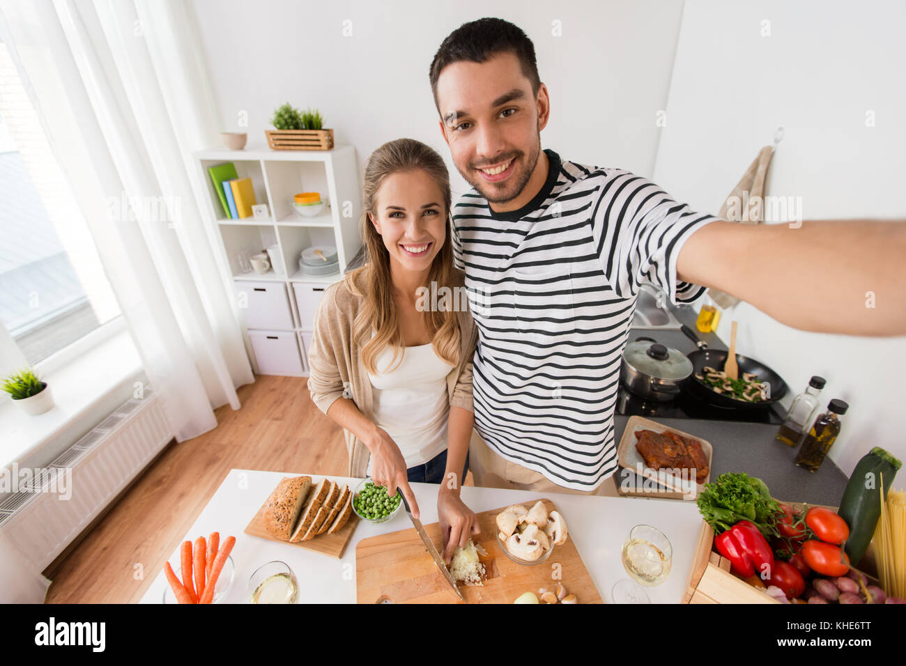 couple cooking food and taking selfie at kitchen Stock Photo - Alamy