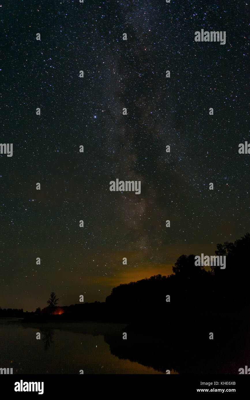 Colorful night view of the lake, the Milky Way, the forest and the ...