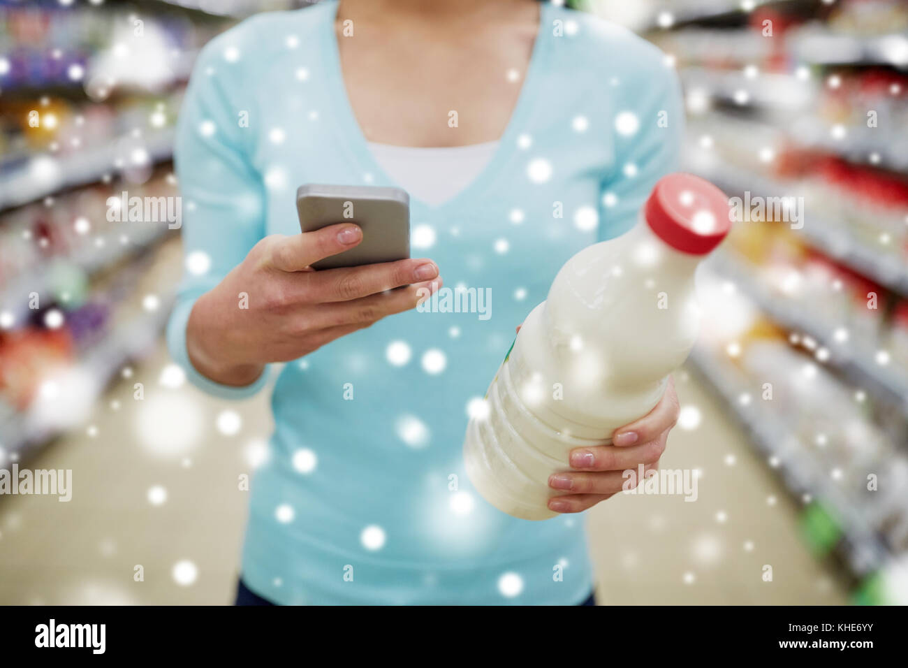 customer with smartphone and milk at supermarket Stock Photo - Alamy