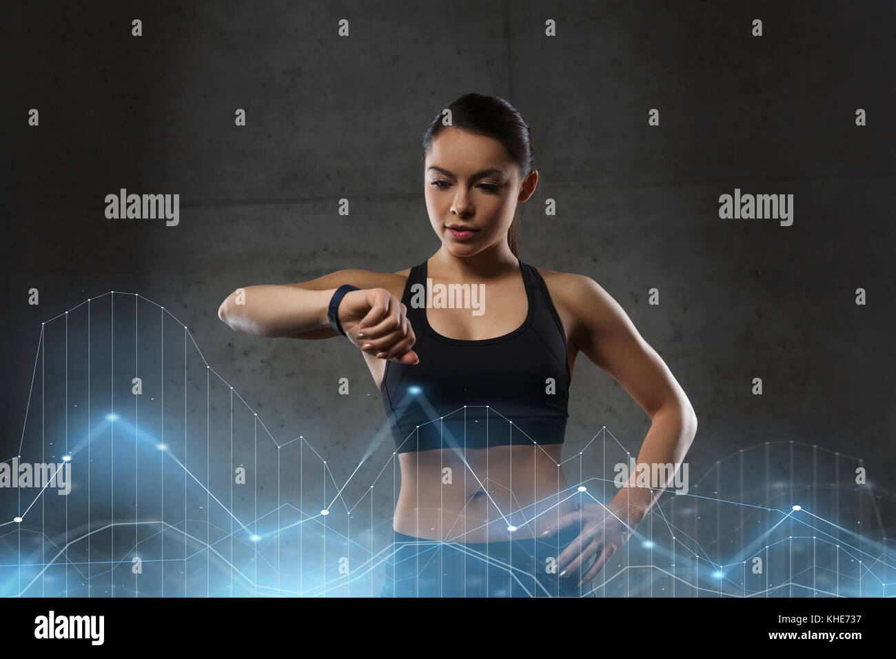 young woman with heart-rate watch in gym Stock Photo - Alamy