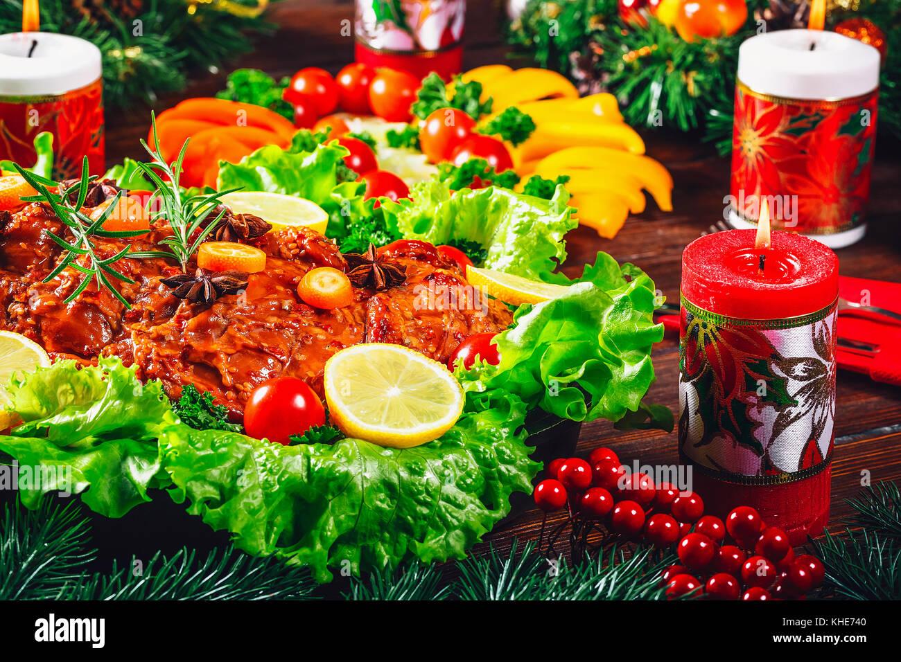 Christmas table dinner time with roasted meats, candles and New Year ...