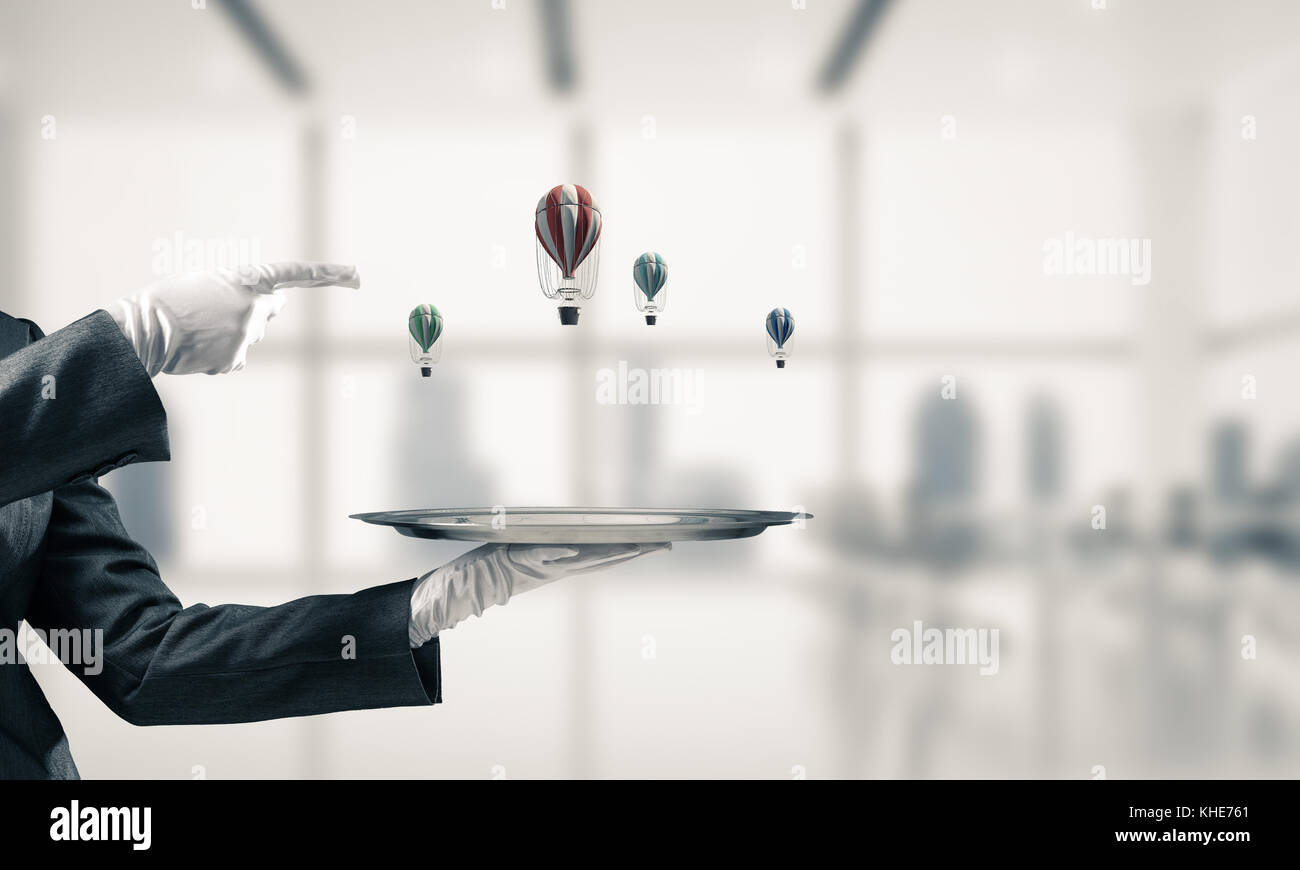 Hand of waiter presenting balloons on tray Stock Photo - Alamy