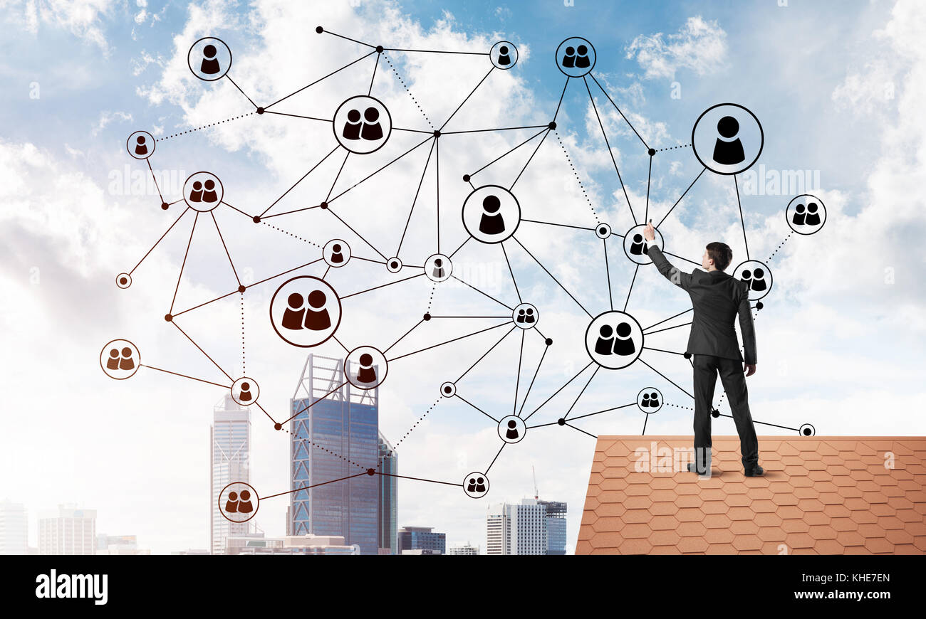 Businessman on house roof presenting networking and connection concept ...