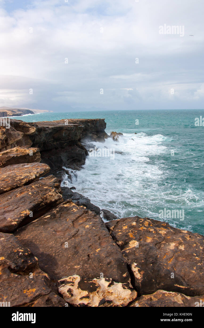 high cliff with bouncing waves in fuerteventura Stock Photo - Alamy