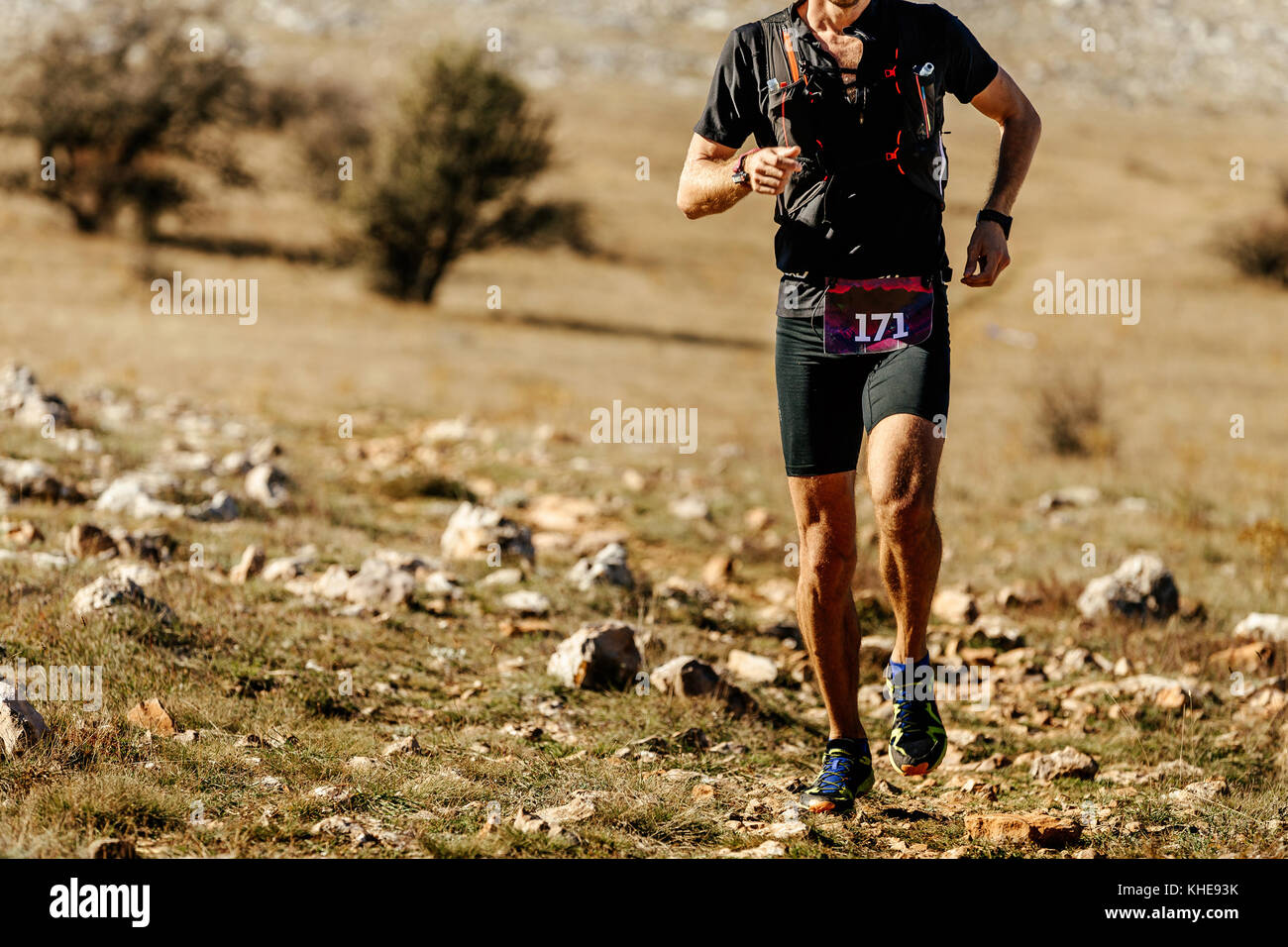 man athlete runner leader of mountain marathon running stones trail ...