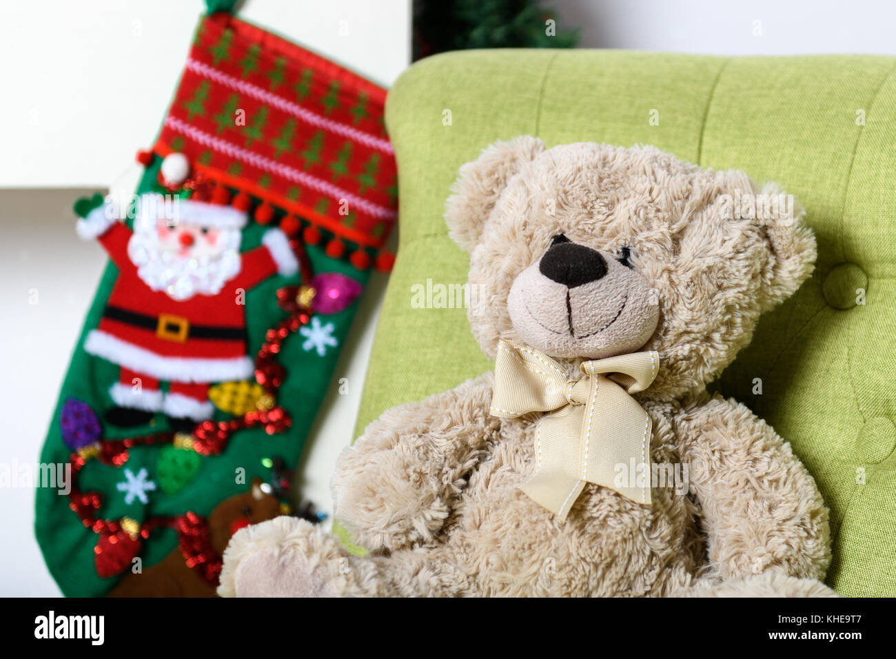 Teddy bear in a chair under the Christmas tree Stock Photo - Alamy