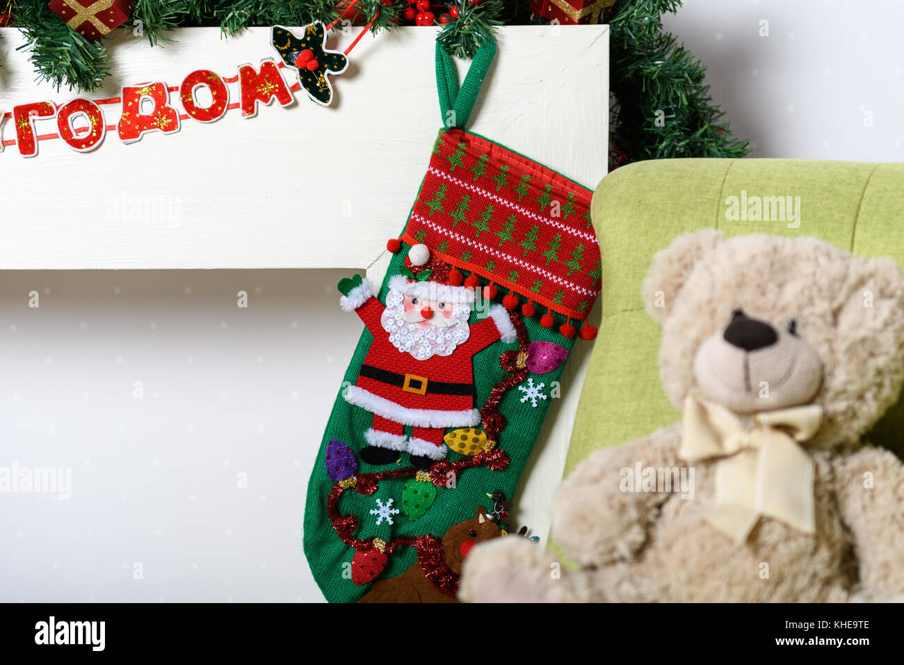 Teddy bear in a chair under the Christmas tree Stock Photo - Alamy