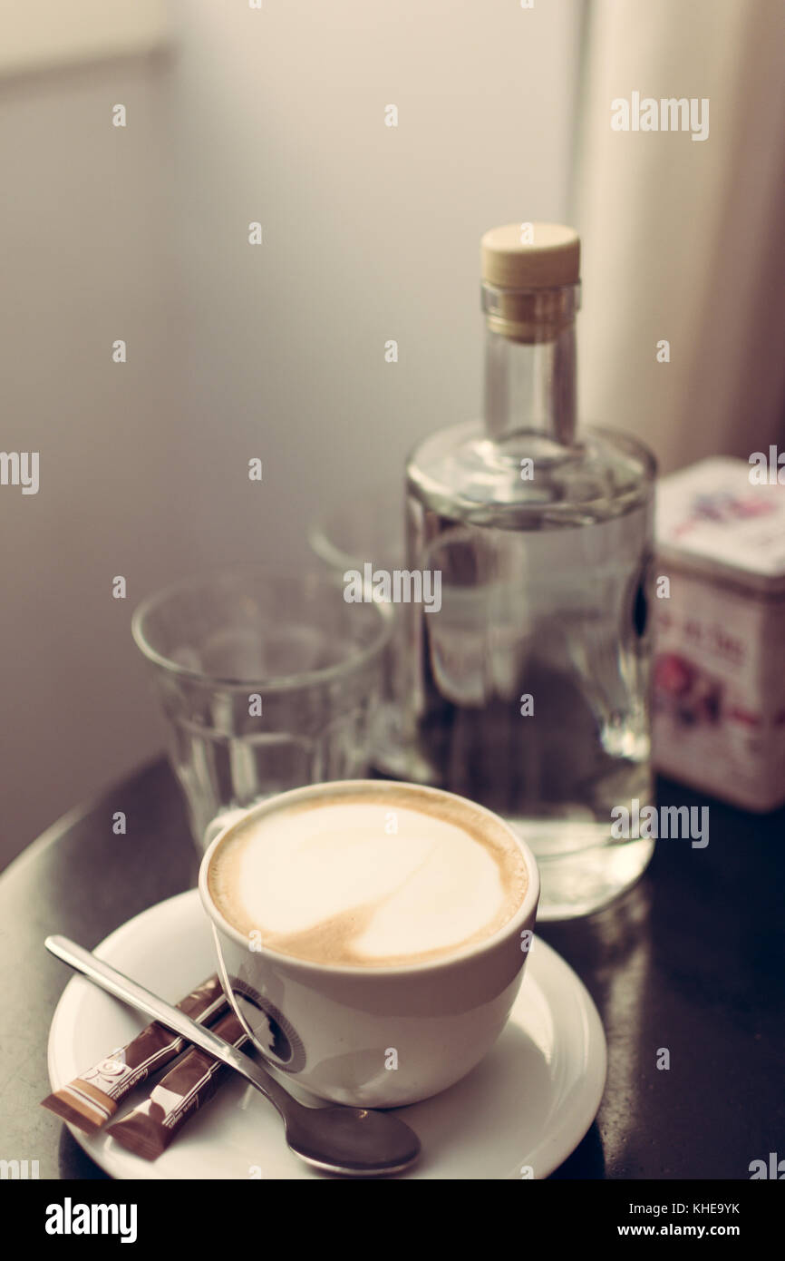 Cappuccino coffee,cookies and water. Made in soft warm effect.Vertical ...