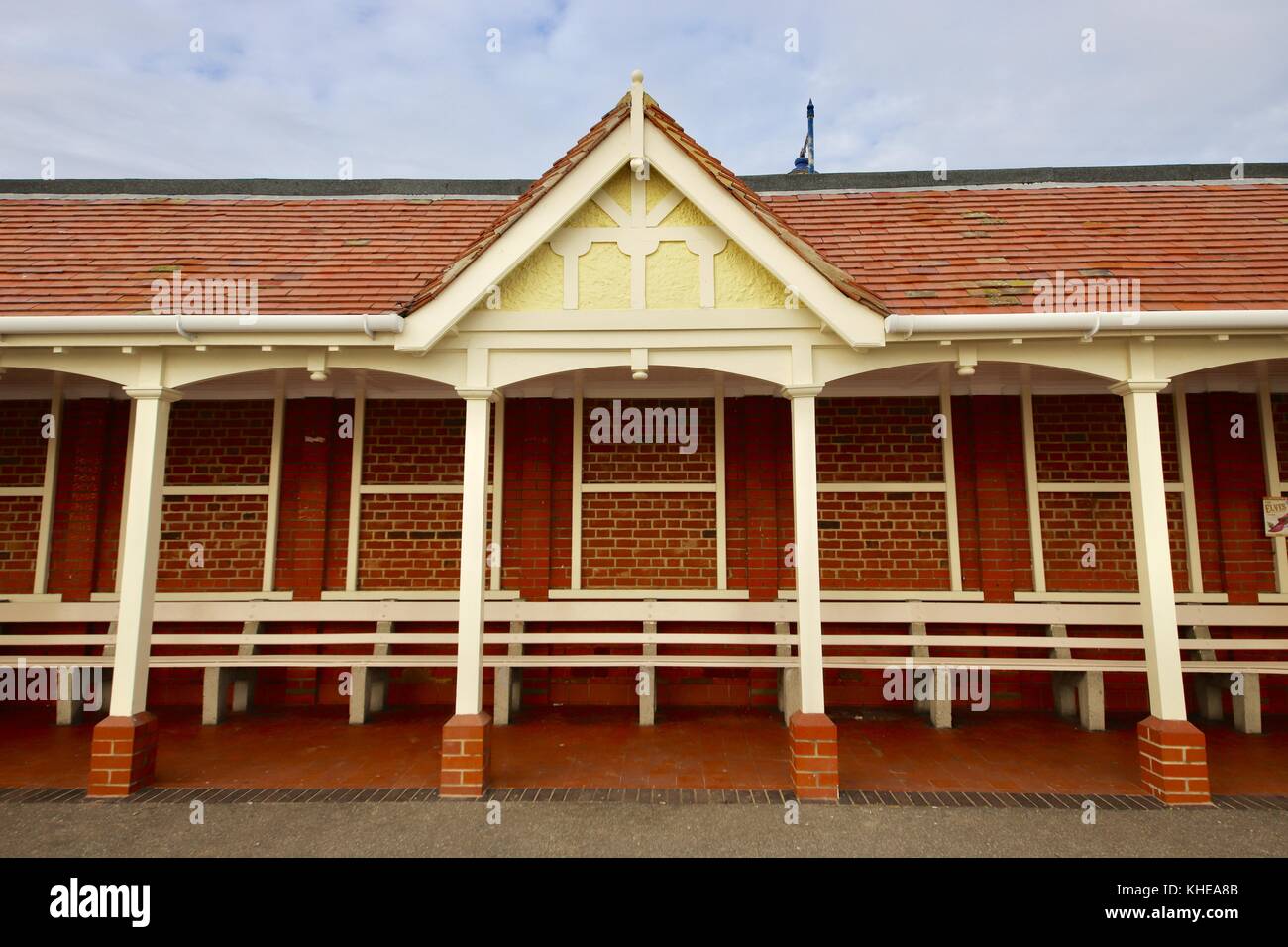 Red brick covered bench seating on the seafront at Felixstowe, Suffolk ...