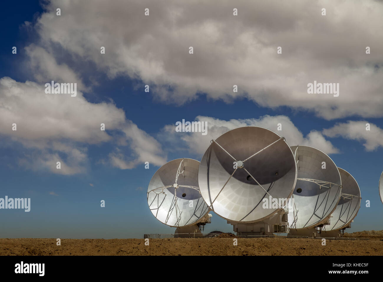 Four satellite dishes out of 60 of ESO's ALMA array pointed to the side ...