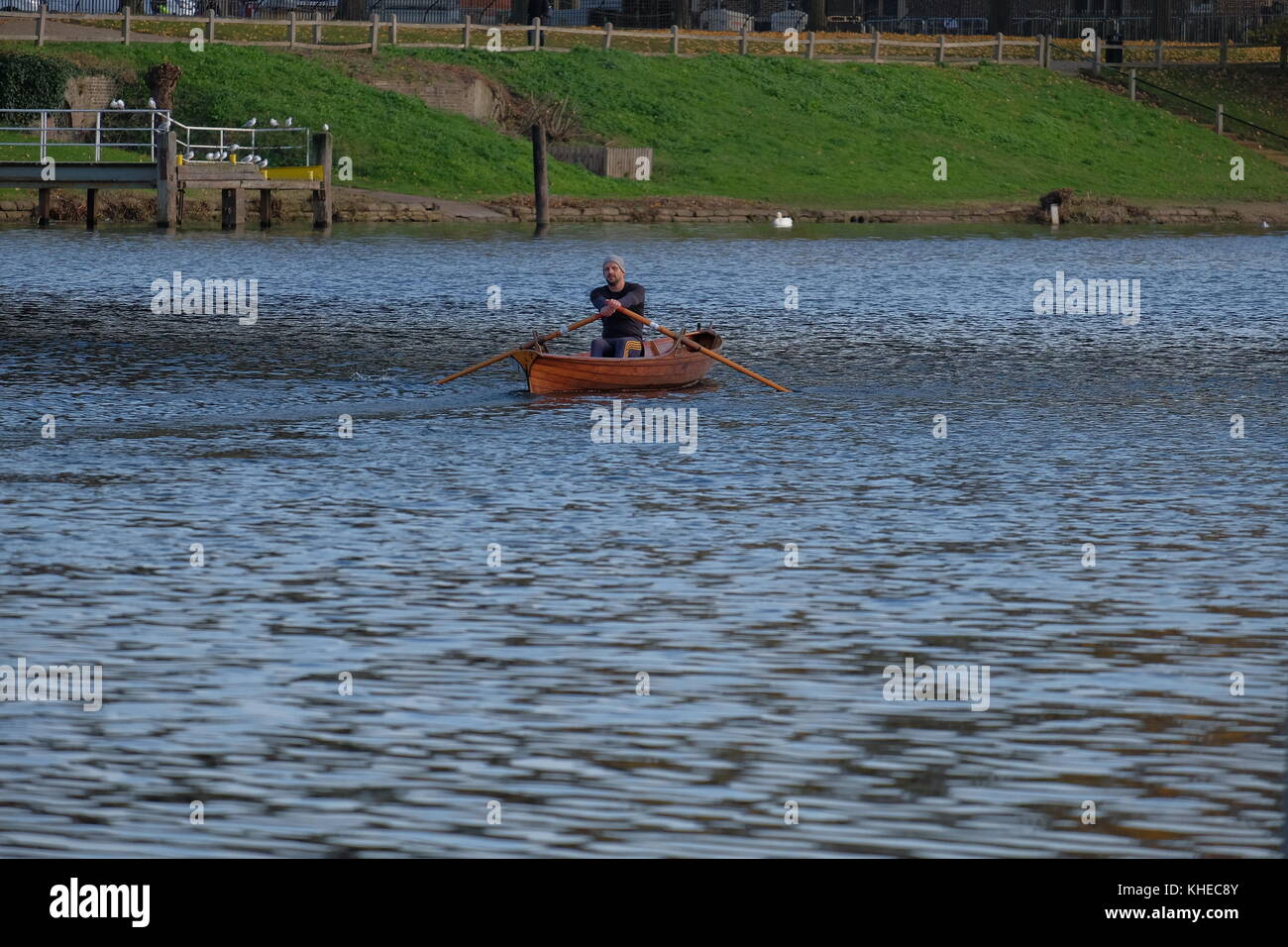 man rowing wooden skiff boat on river thames Stock Photo - Alamy