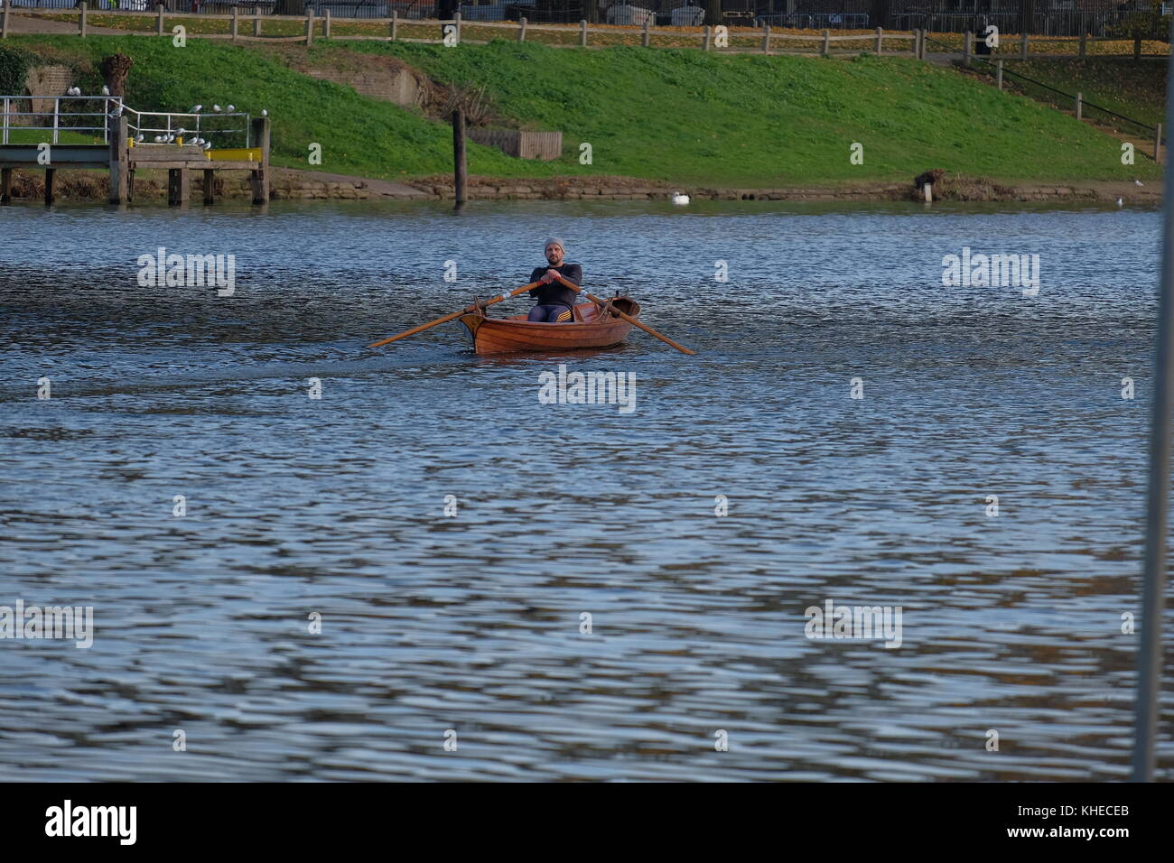 man rowing a skiff boat Stock Photo - Alamy