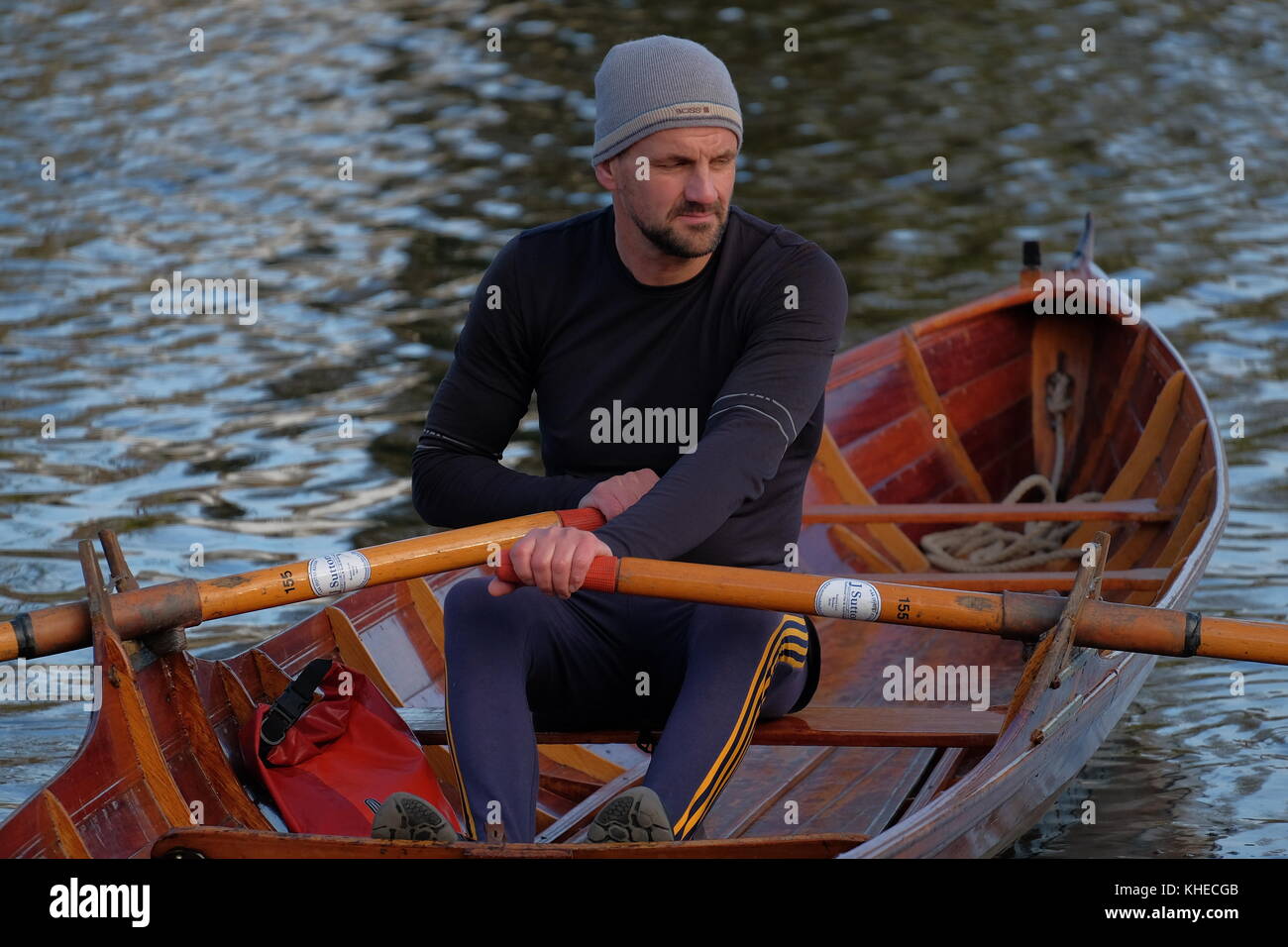 man rowing wooden skiff boat on river thames Stock Photo - Alamy