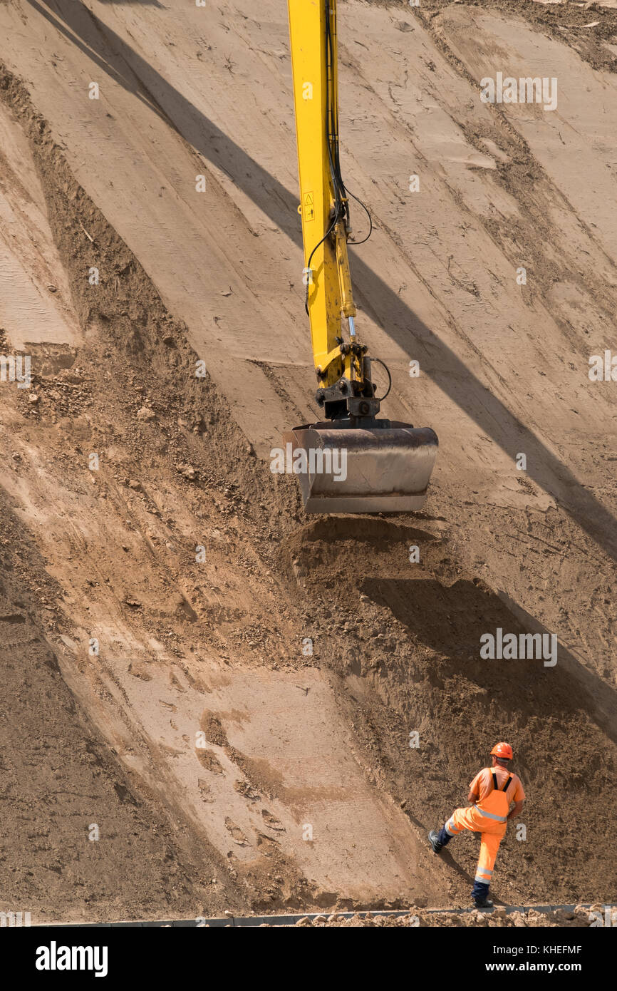 Digger works at new road construction site Stock Photo - Alamy