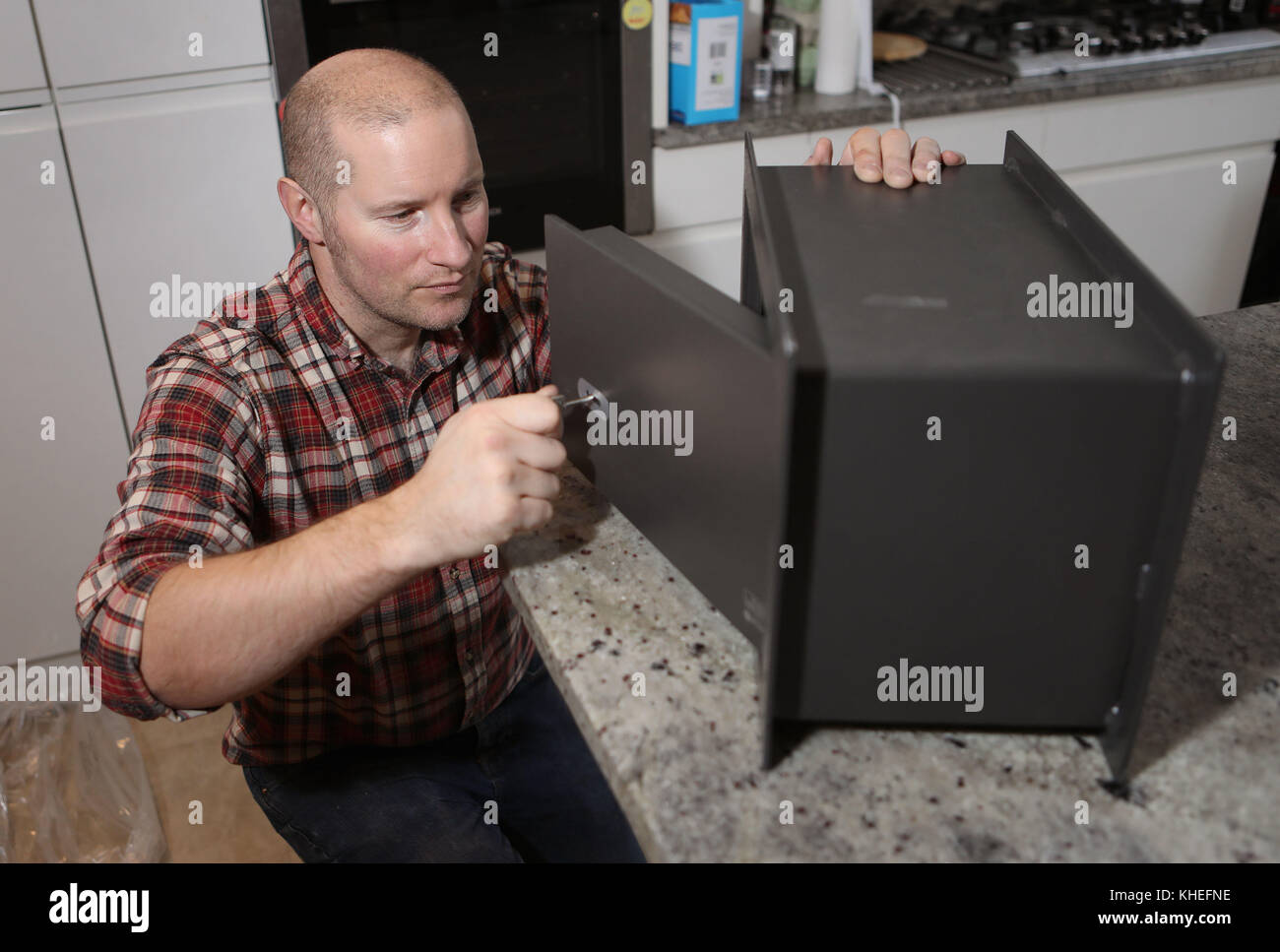 Richard Burr checks a new safe for his DIY feature column Stock Photo ...