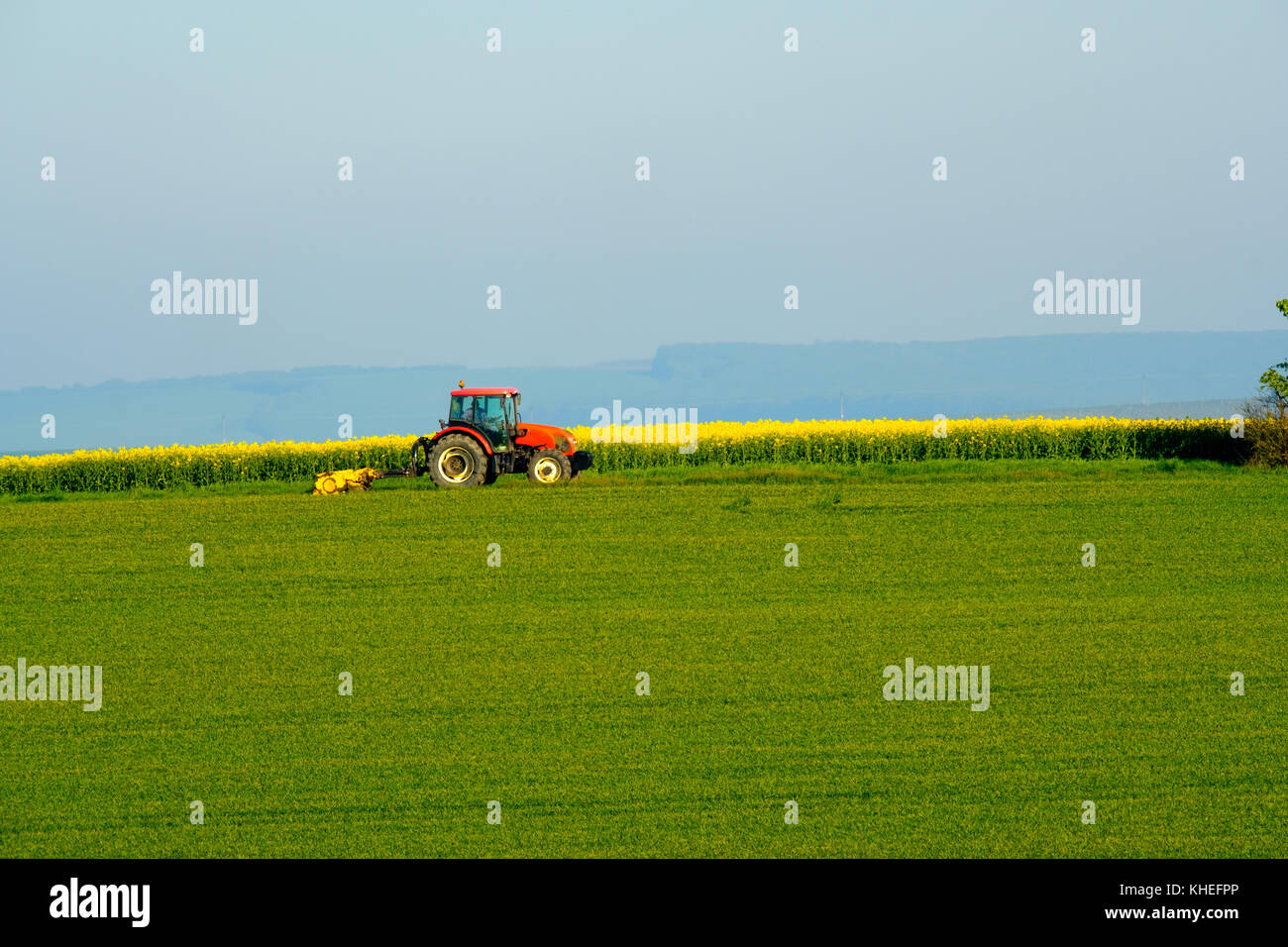 Agricultural tractor working in a countryside Stock Photo - Alamy