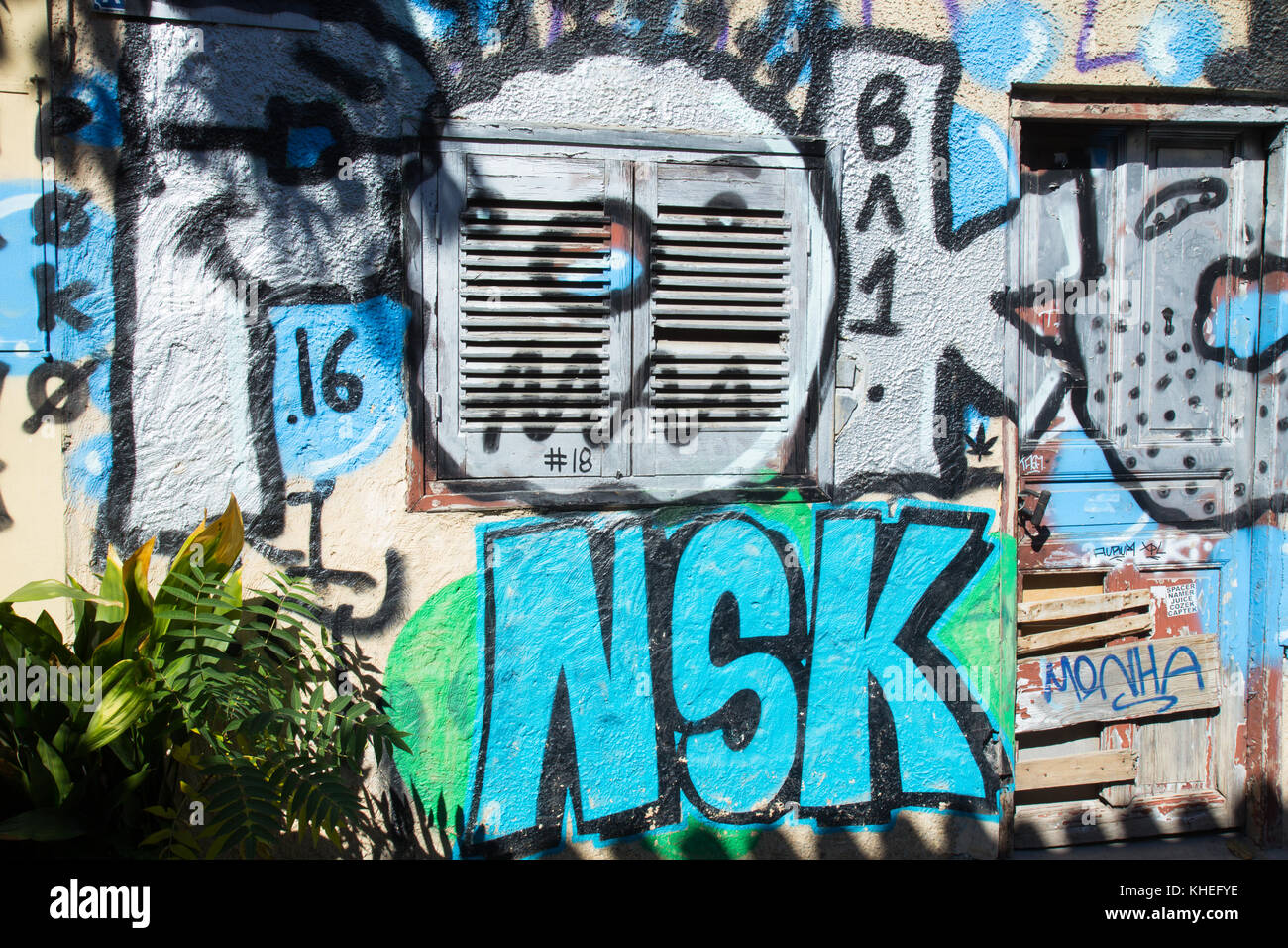 Graffiti with letters and numbers in a small street in Plaka region of ...