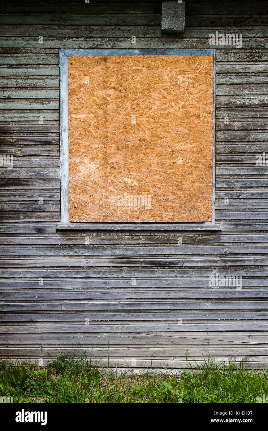 Weathered wooden plank house wall with boarded up window Stock Photo ...
