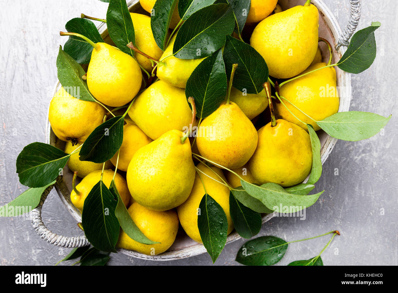 Yellow pear in grey basket in grey background. Harvest. Top view. Full ...