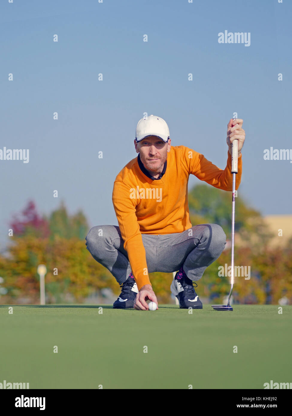 Lining up the birdie putt, checking out the line Stock Photo - Alamy