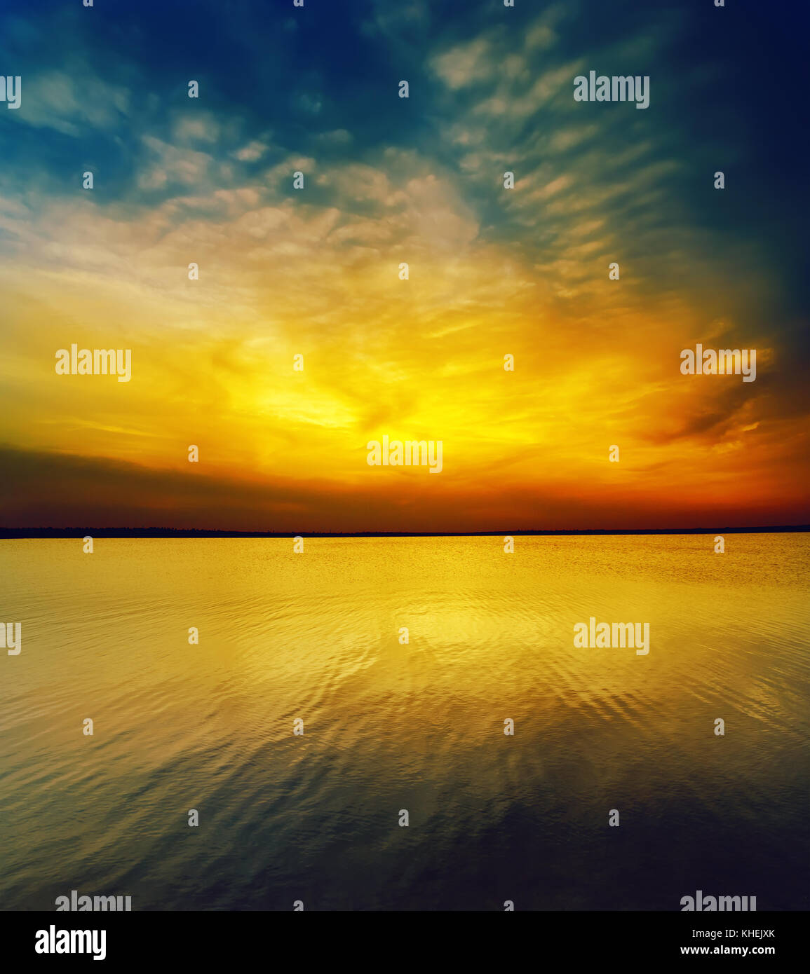 fantastic sunset over dark water Stock Photo - Alamy