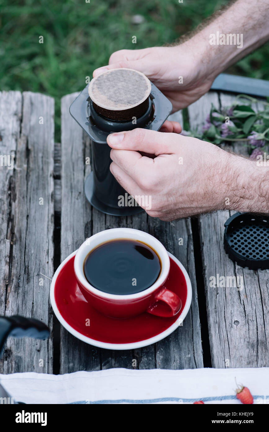 Fresh coffee puck, left from making filter coffee outdoors on the ...