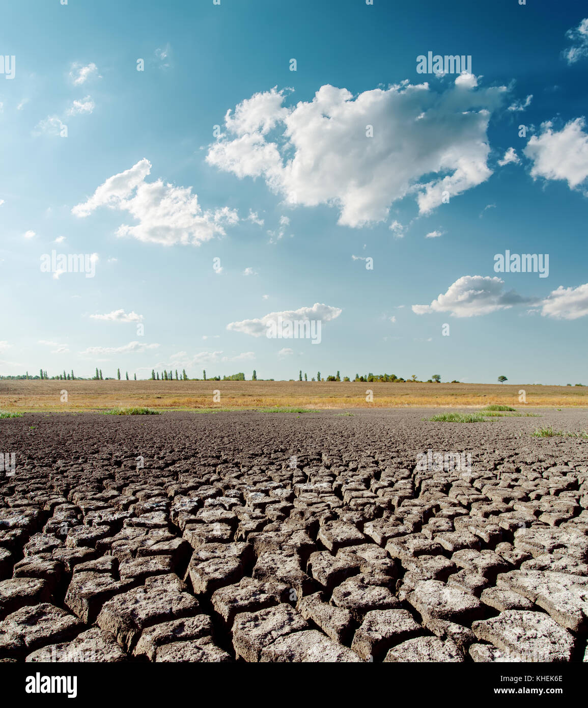 dry desert under blue sky with clouds Stock Photo - Alamy