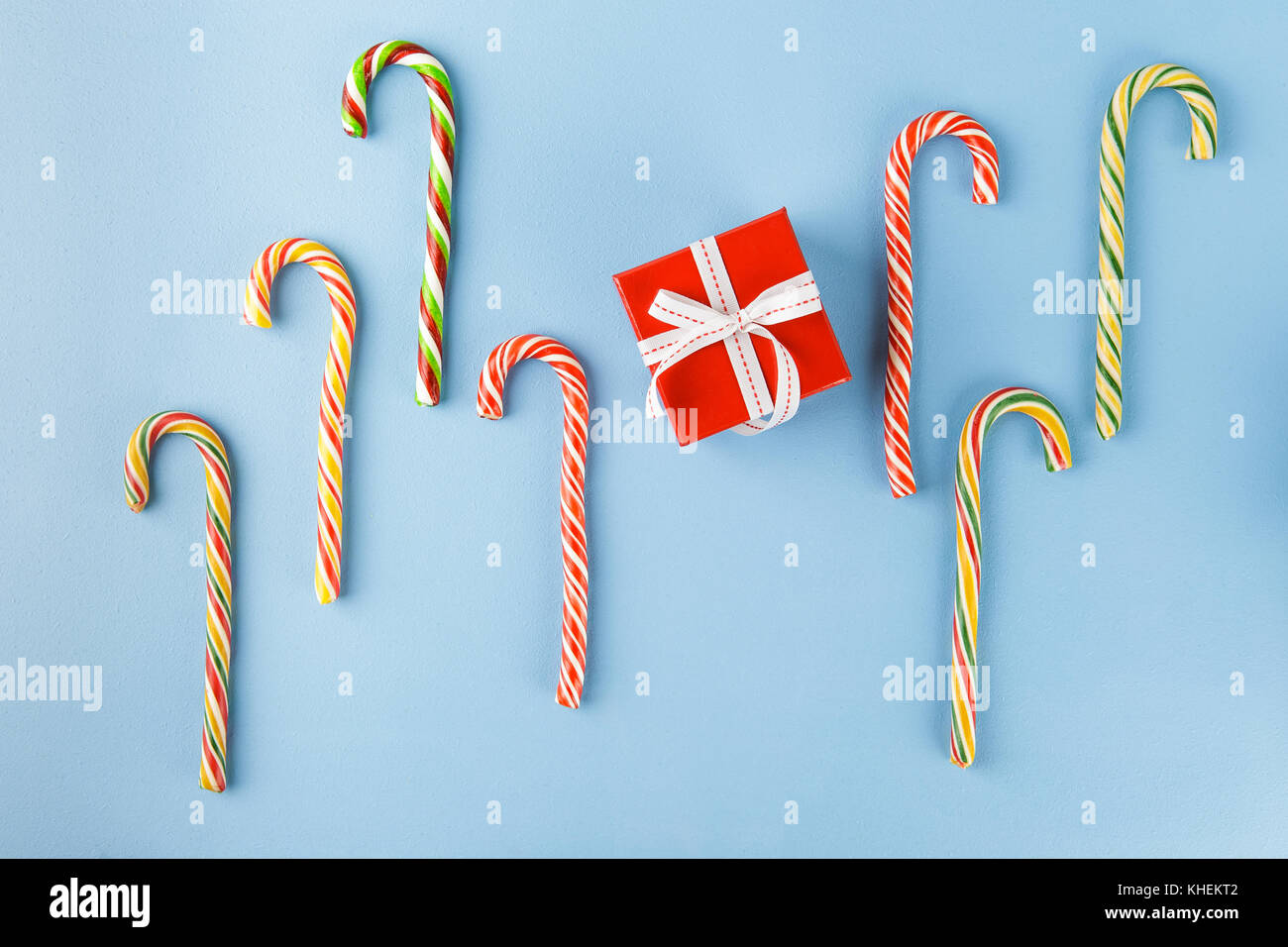 Christmas red gift boxes and Candy canes onblue background. Flat lay ...
