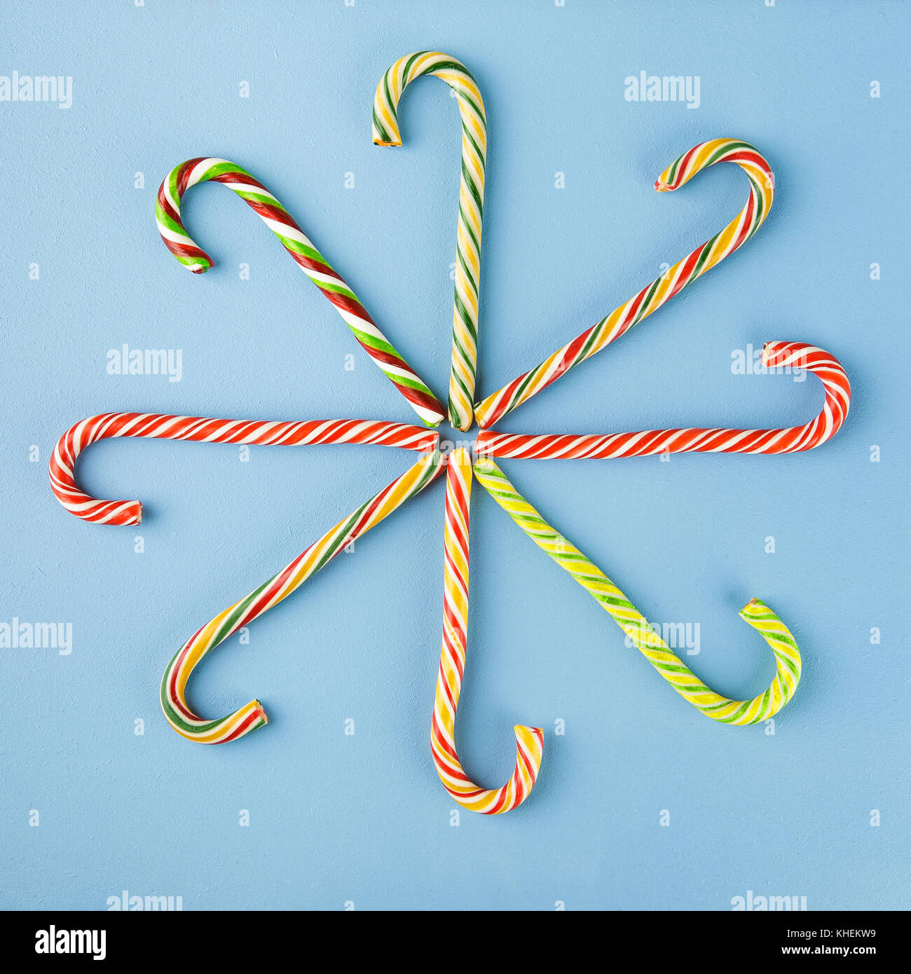 Sweet Candy canes on blue background. Flat lay. Top view Stock Photo ...