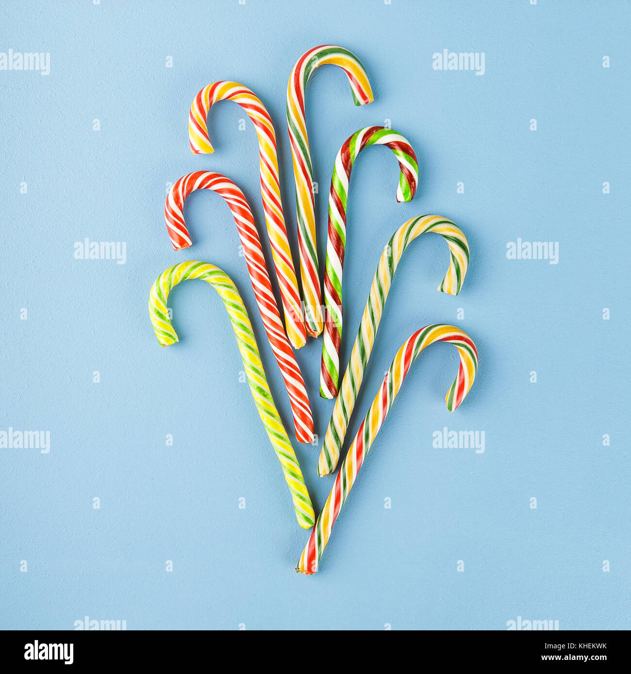 Sweet Candy canes on blue background. Flat lay. Top view Stock Photo ...