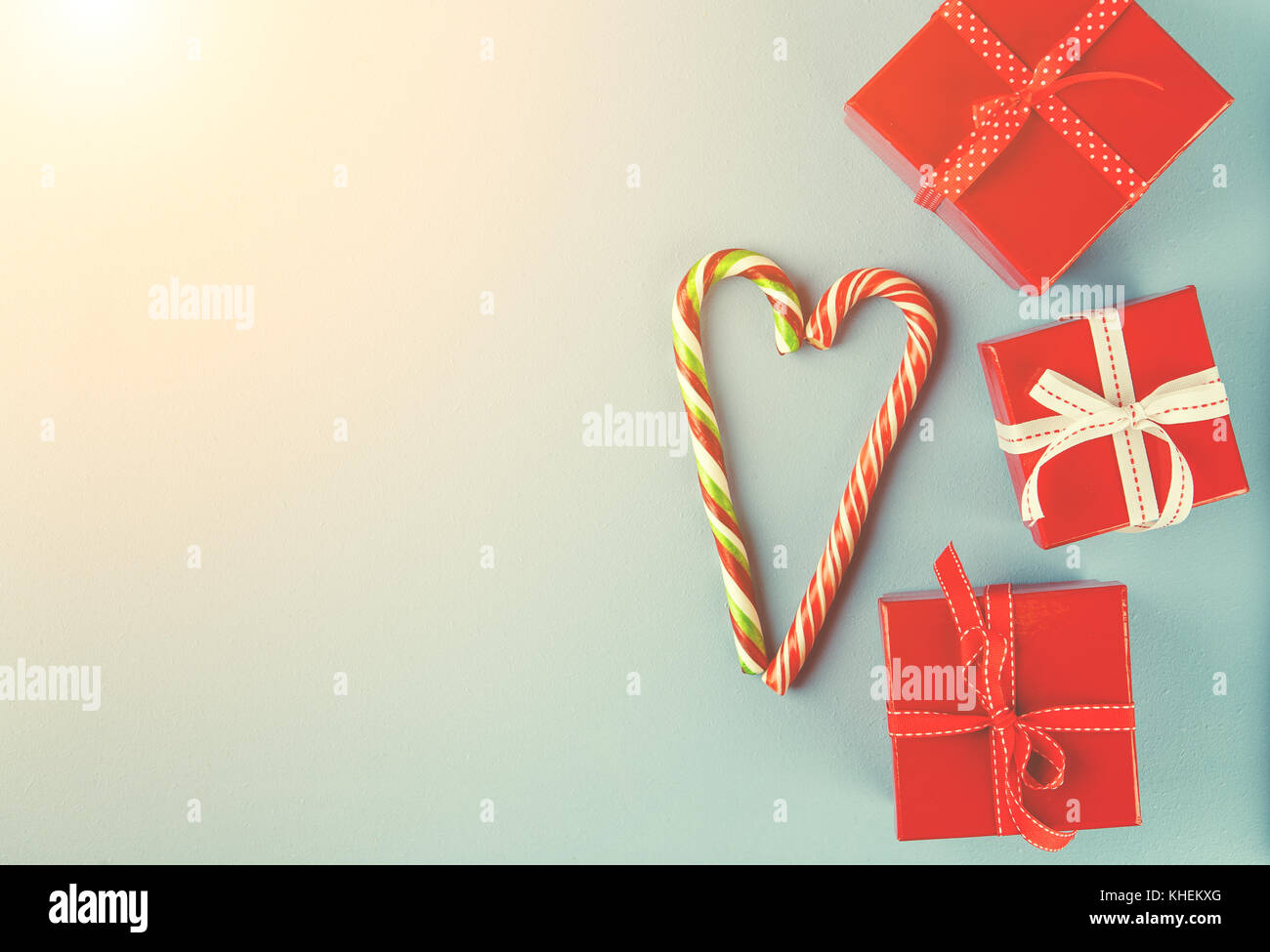 Christmas red gift boxes and Candy canes onblue background. Flat lay ...