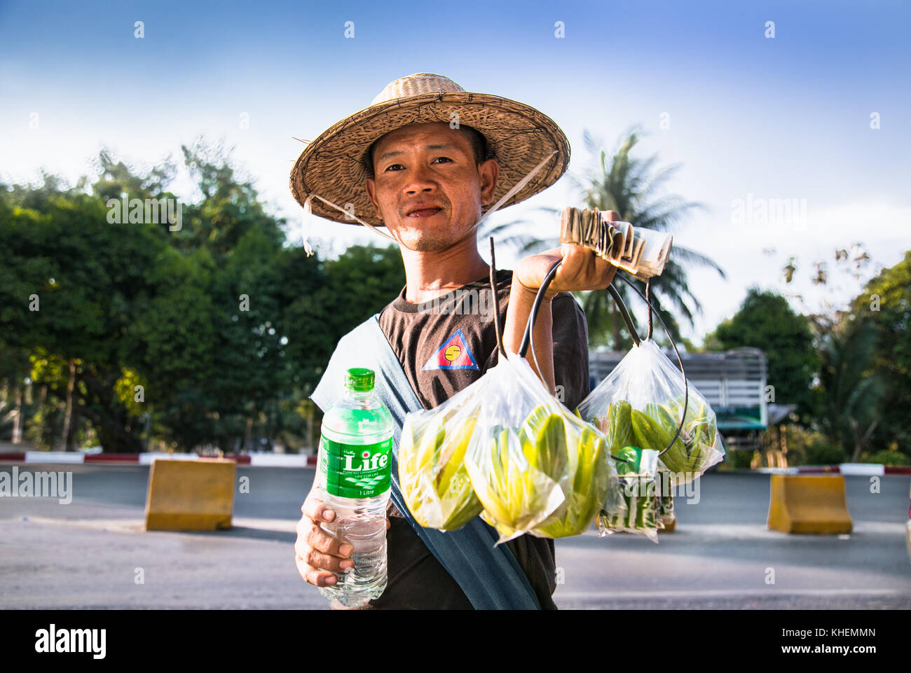 YANGON, MYANMAR - MARCH 3, 2017: Burmese poor man selling street fruits ...