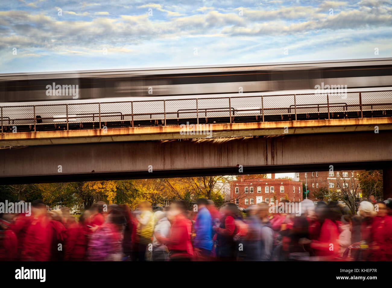 Runners leaving the starting line as a train departs behind in ...