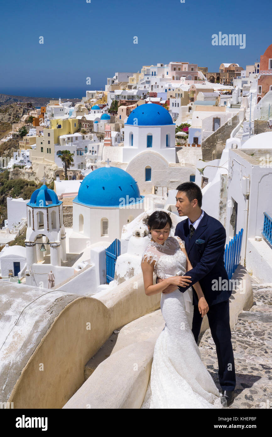 Bridal couple in front of orthodox church at the village Oia, Santorin ...