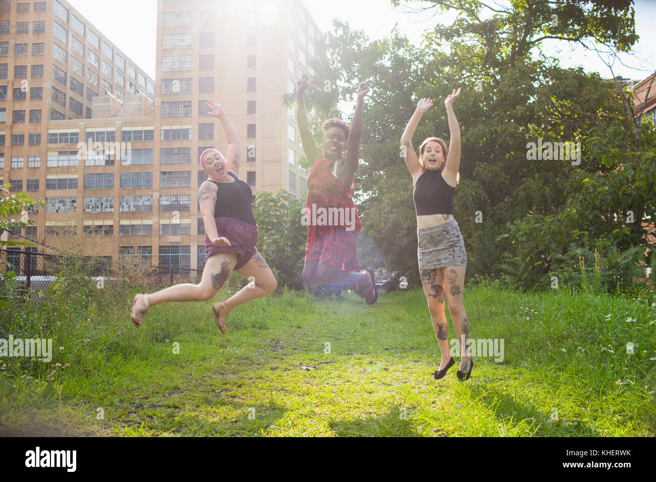 Three young women jumping Stock Photo - Alamy