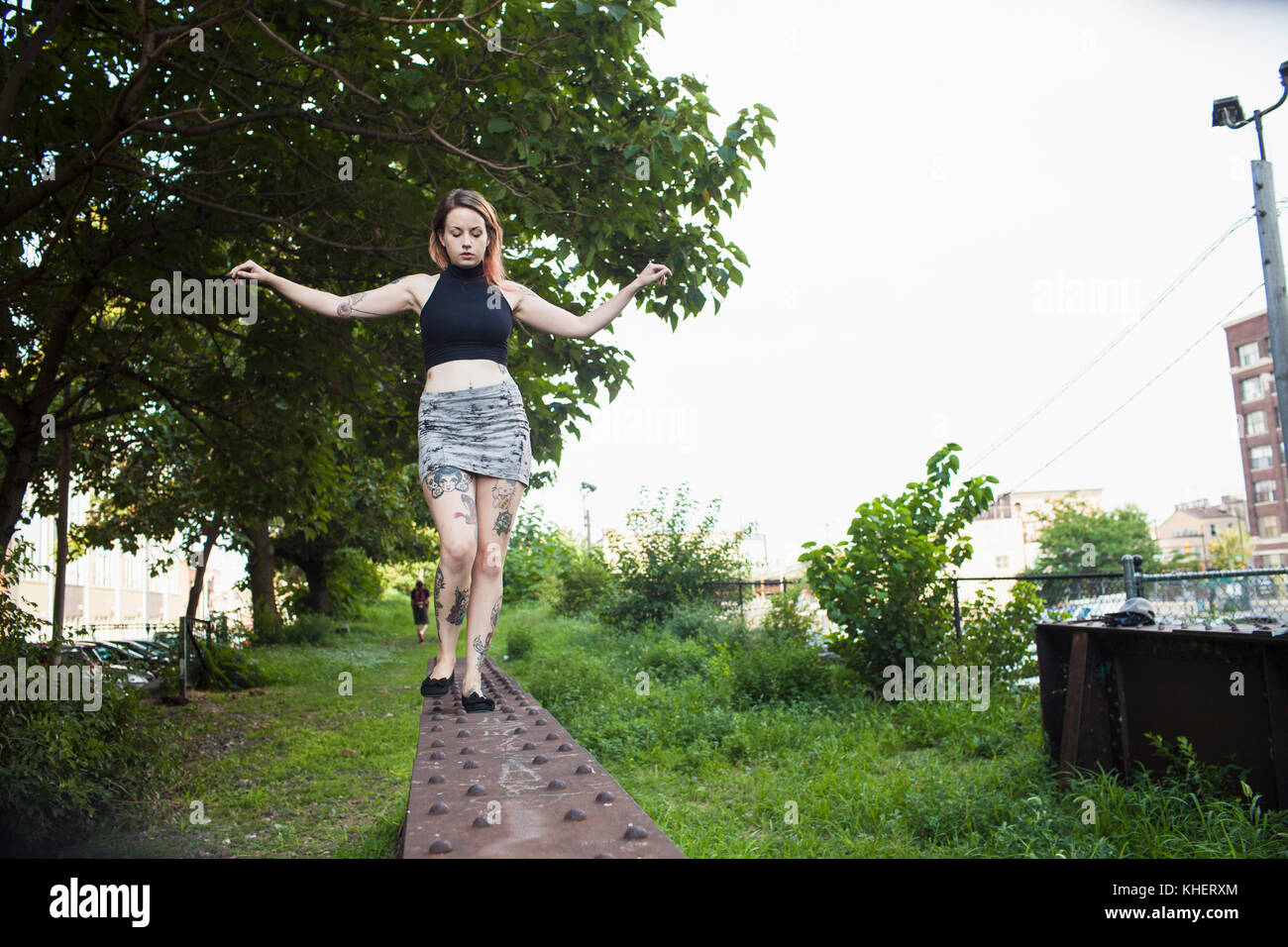 A young woman balancing on a bench Stock Photo - Alamy