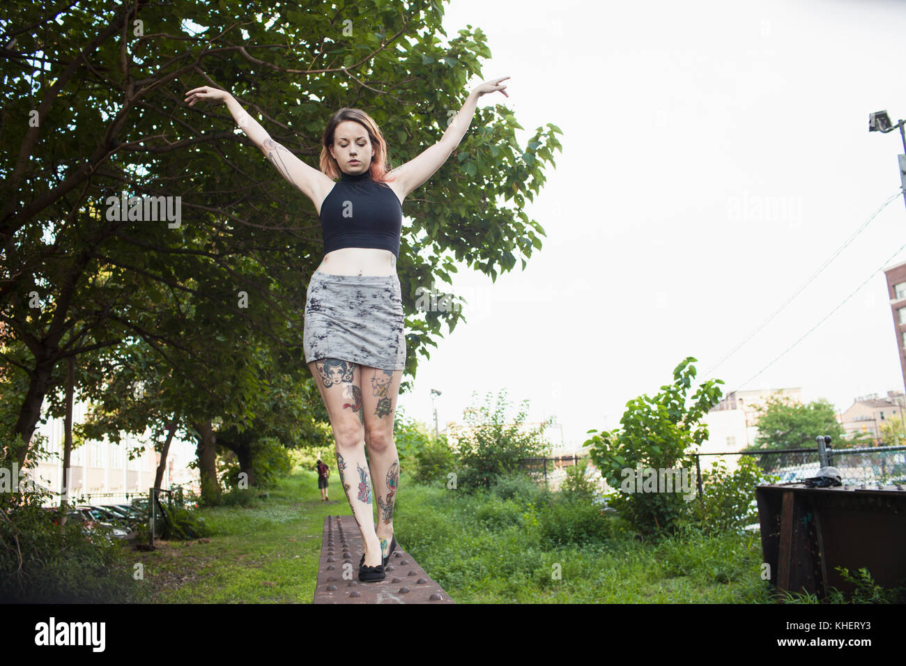 A young woman balancing on a bench Stock Photo - Alamy