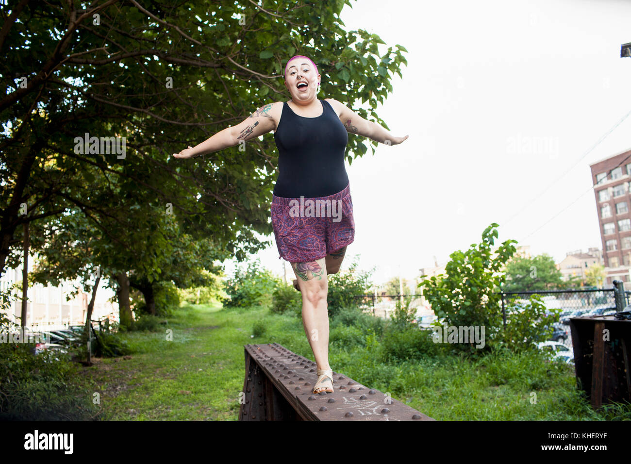 A young woman balancing on a bench Stock Photo - Alamy
