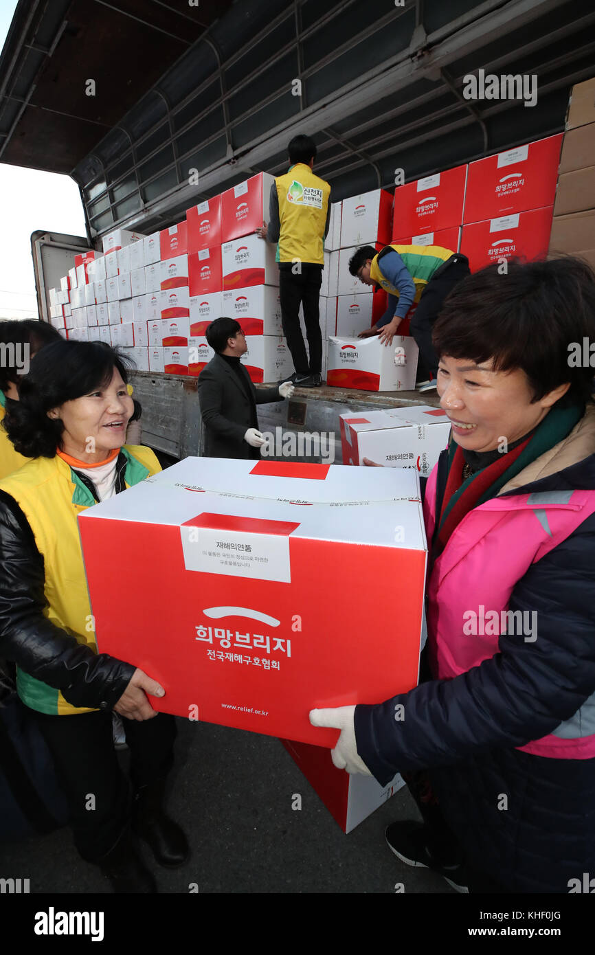 17th Nov, 2017. Relief goods for quake victims Two workers carry relief ...