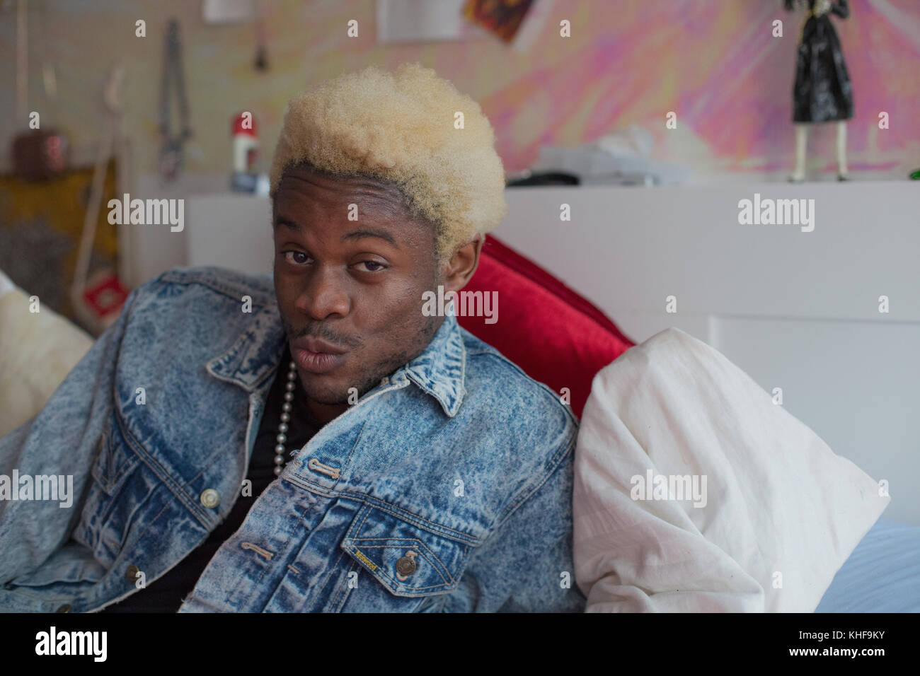 Young man hanging out on his bed Stock Photo - Alamy