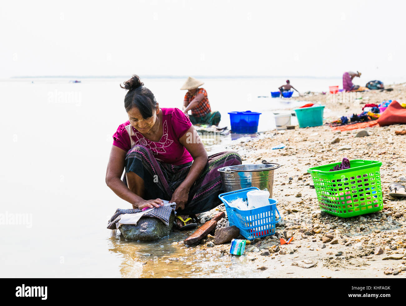 MINGUN, MYANMAR - MARC 6, 2017: Burmese women washing clothes on the ...