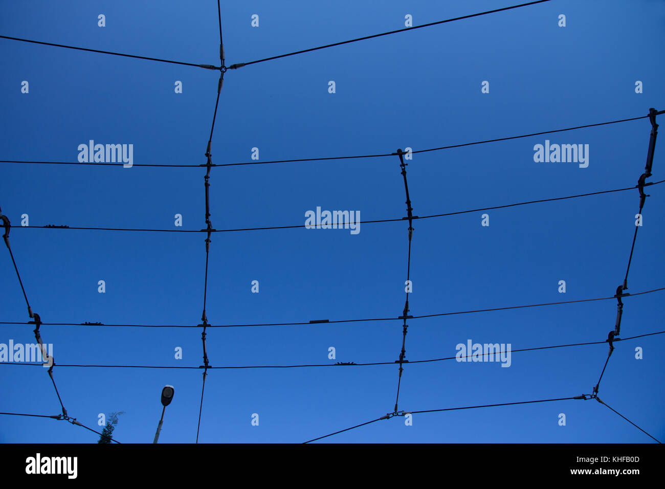 Electricity cables forming a pattern in the sky Stock Photo - Alamy