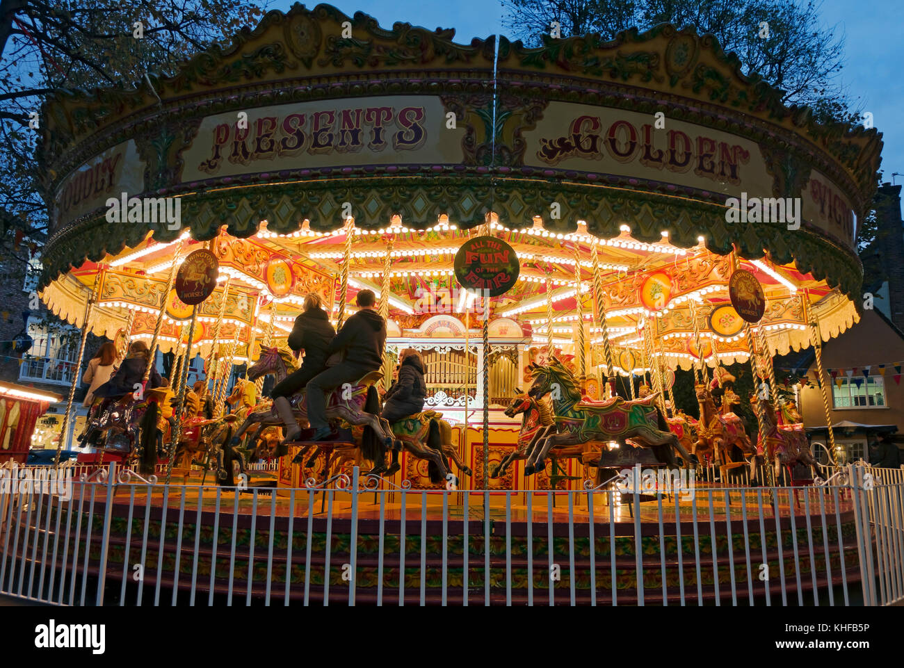 People riding on merry go round carousel ride York North Yorkshire ...