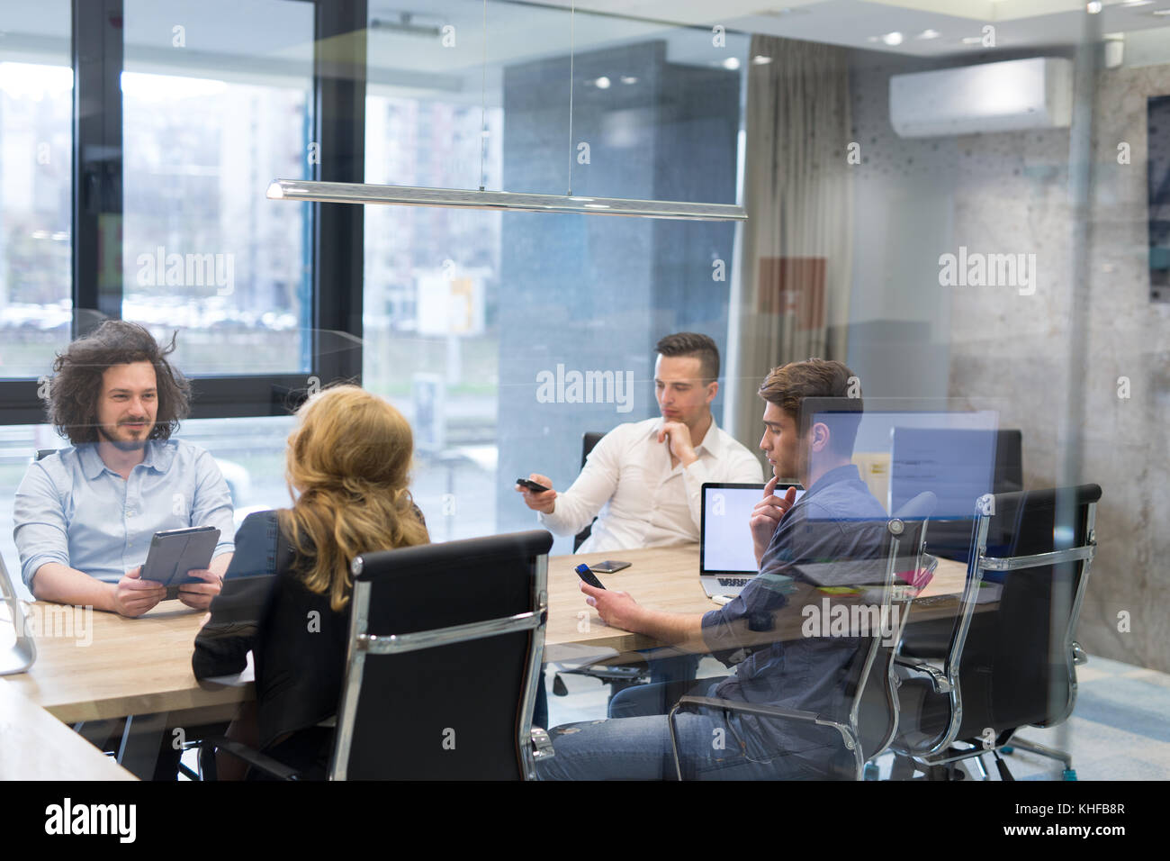 Group of a young business people discussing business plan at modern ...