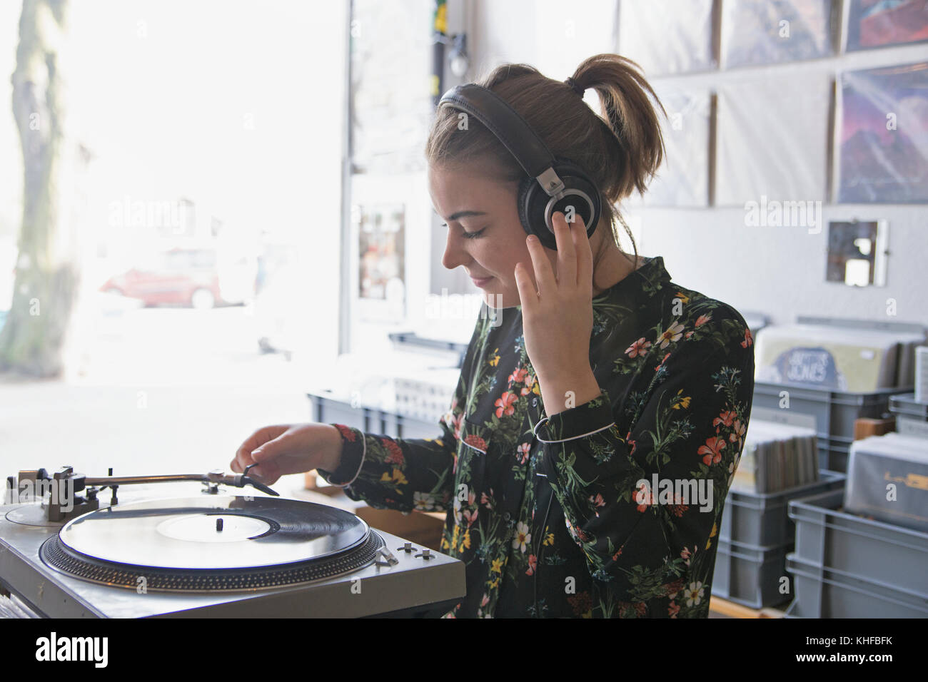 Woman listening vinyl records in hi-res stock photography and images ...