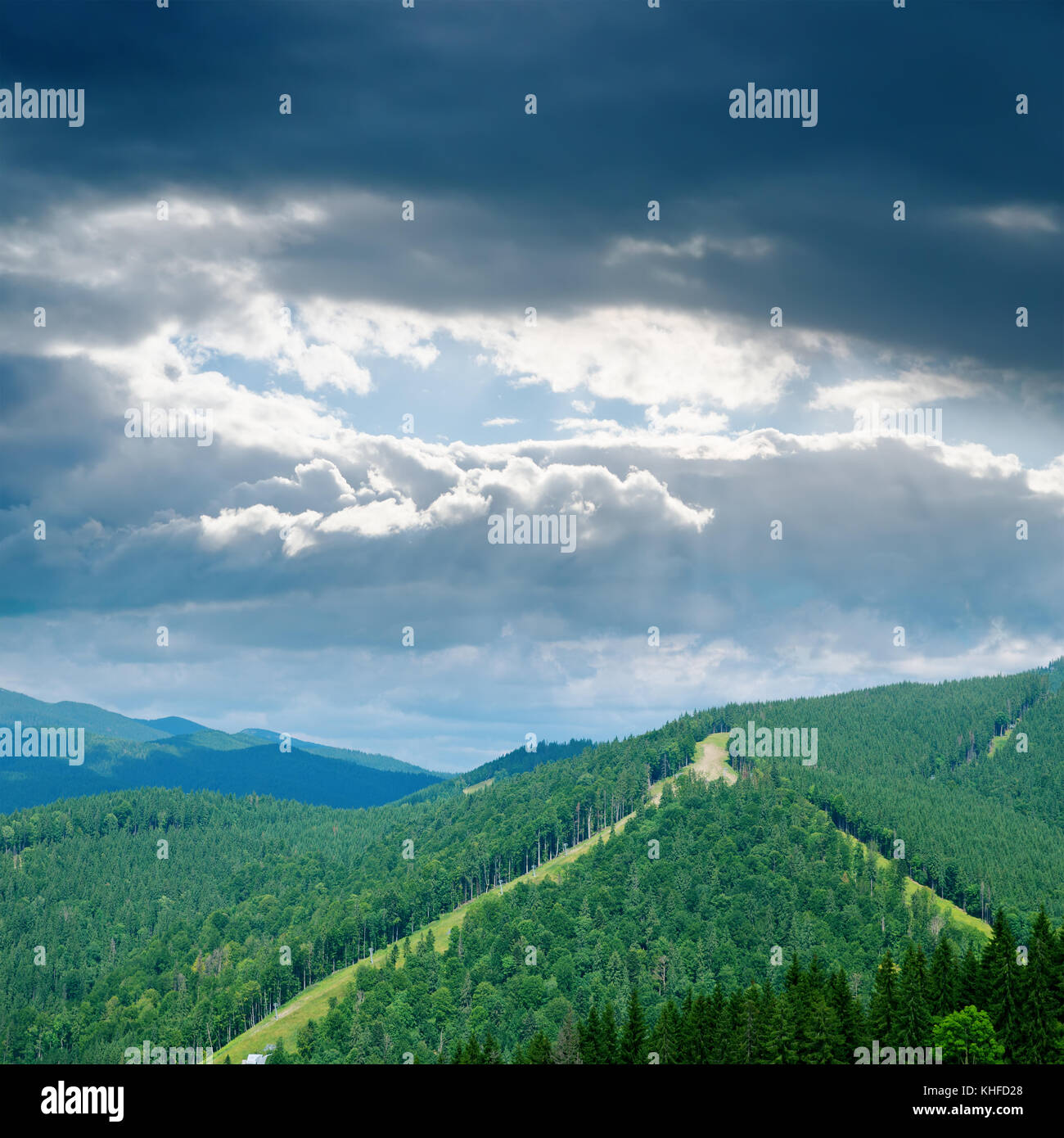 dramatic low clouds over green mountain Stock Photo - Alamy