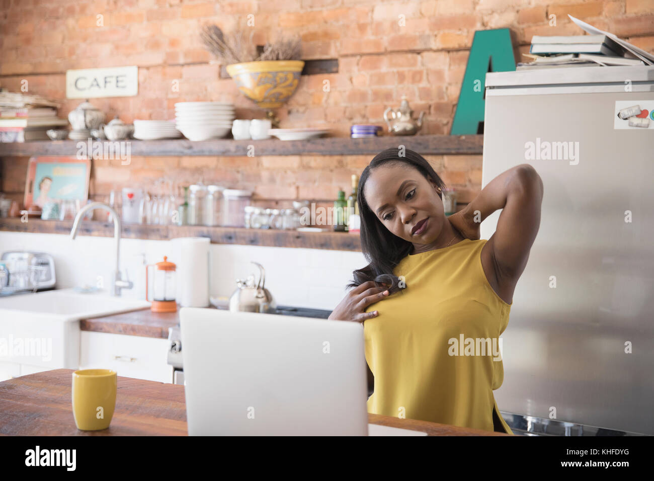 Businesswoman stretching while working at home Stock Photo - Alamy
