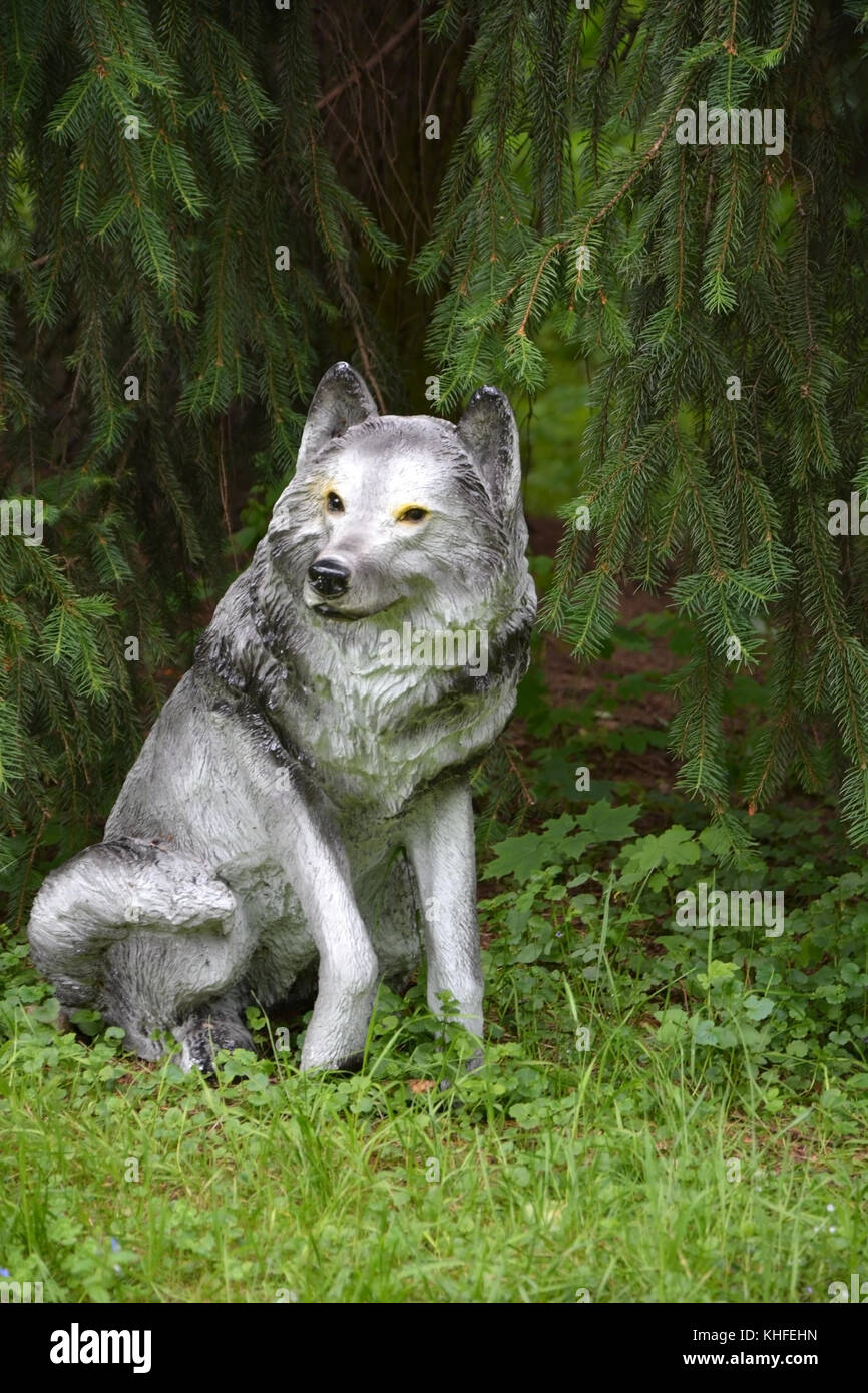 Toy- grey wolf under the fir tree Stock Photo - Alamy