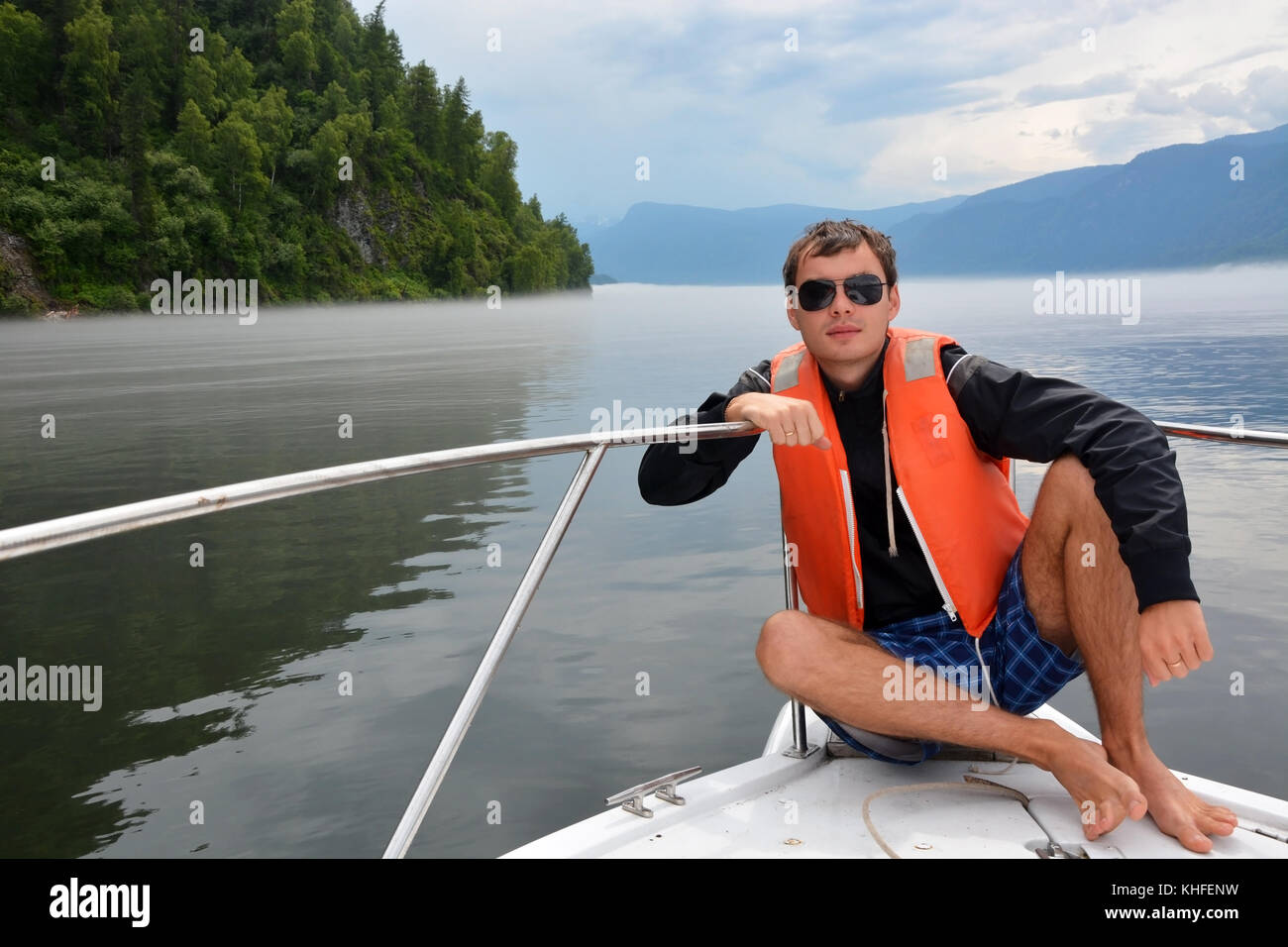 Young man at the lake Stock Photo - Alamy